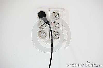 Black Electrical Wire With Plug Plugged Into Socket And Five Free ...