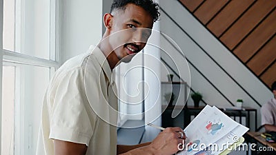 Black Man Reading a Document and Talking with a Colleague in a Fancy ...