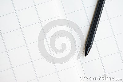 Black Pen Placed On A Notepad With Block Grid Pattern. Royalty-Free ...