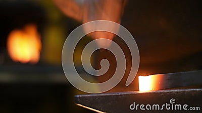 Blacksmith Hitting Hot Metal with a Hammer on an Anvil Inside His ...