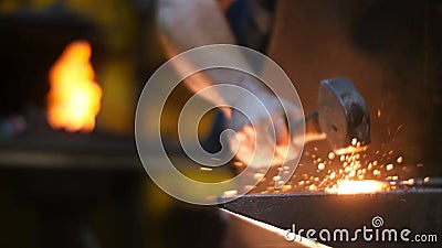 Blacksmith Hitting Hot Metal with a Hammer on an Anvil Inside His ...