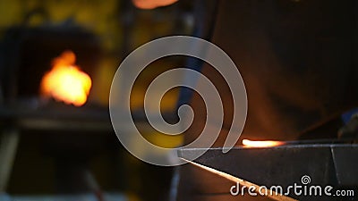 Blacksmith Hitting Hot Metal with a Hammer on an Anvil Inside His ...