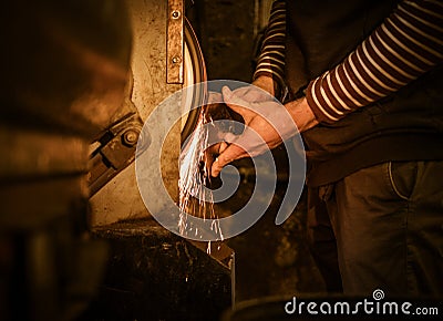 The Blacksmith Sharpening An Ax On Electrical Grinder Stock Photo ...