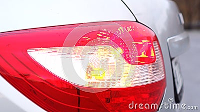 Blinking on a Rear Light of a Silver Modern Car in a Suburban Area ...