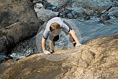 Boy Climbing Up A Rock Royalty Free Stock Photo - Image: 22386285