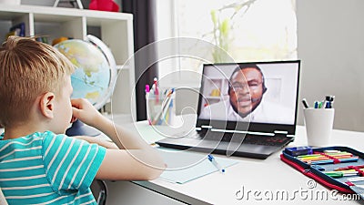 Boy is Doing His Homework at the Table. Cute Child is Learning at Home ...