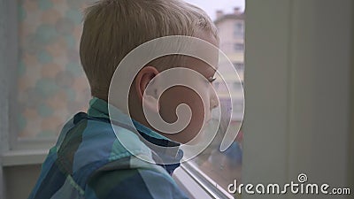 Boy Looking Out the Window Waiting for Parents at Home Alone Stock ...