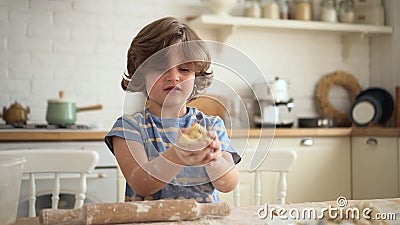 Boy Making Pastry and Having Fun while Sitting at Table in Home Kitchen ...