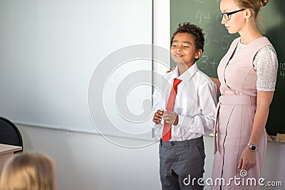 Boy Solving Addition And Subtraction On Board. Schoolboy Writing ...