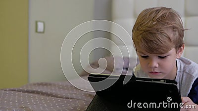 Boy Watching Tablet while Lying on Bed Stock Footage - Video of happy ...