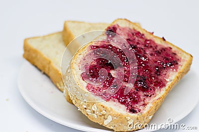 Bread With Spread Jam On The Dish On White Isolate Background Stock ...