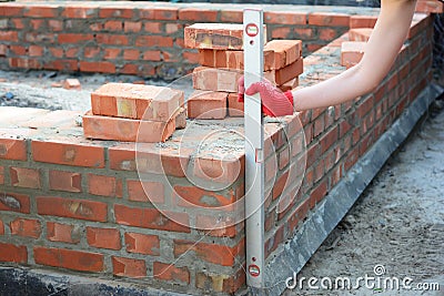 Bricklayer Using A Spirit Level To Check Bricklaying Wall Outdoors ...