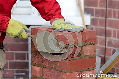 Bricklaying - Laying A Brick Stock Photo - Image: 49094750