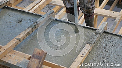 Builder on Formwork Foundation Uses the Vibrator To Concrete Has Left ...