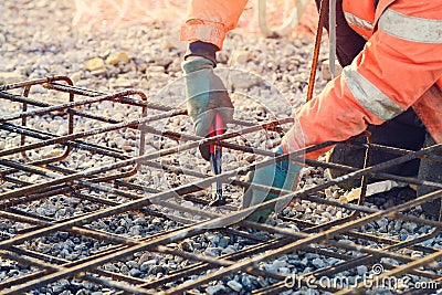 Builder`s Hands Fixing Steel Reinforcement Bars At Construction Site ...