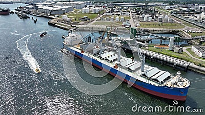 Bulk Carrier Ship at Port Offloading Cargo and Commodities by Shore ...