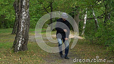 A Business Man in a Hat and Coat in the Woods Happily Dancing Tapping ...