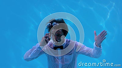 Businessman Underwater in Swimming Pool Talking on Smartphone Stock ...