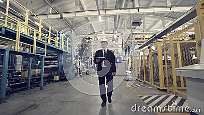 Man Walking through Factory and Talking on Phone Stock Video - Video of ...
