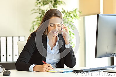 Businesswoman Calling On Phone And Taking Notes Stock Photo - Image ...
