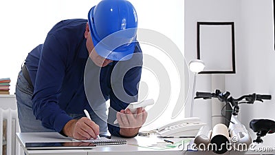 Busy Engineer Make Calculation with Adding Machine and Write in a ...