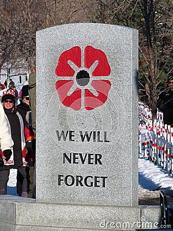 A Poppy On A Commemorative Monument With The Text: We Will Never Forget ...