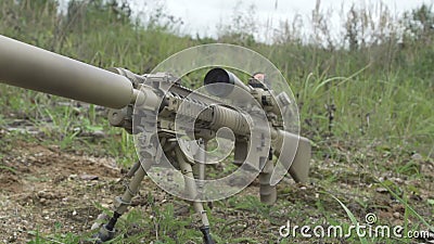 Camouflage Sniper Rifle is on the Ground in the Grass. Airsoft Guns ...