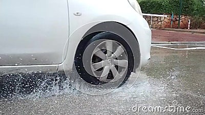 A Car Splashing Water from a Puddle of Water Stock Footage - Video of ...