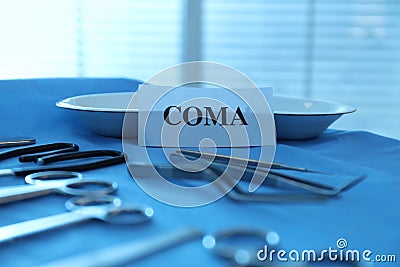 Card With Word Coma And Surgical Instruments On Table, Closeup Royalty ...