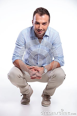 Casual Man Sitting Crouched And Smiling Stock Photo | CartoonDealer.com ...