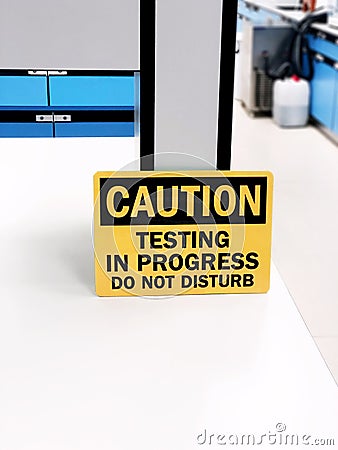 Caution Testing In Progress Do Not Disturb, A Safety Sign Warning On ...