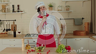 Chef with Dreadlocks Singing into Microphone in Kitchen. Happy Man in ...