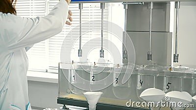 Chemist Take a Sample from Glass Container in Laboratory Stock Footage ...