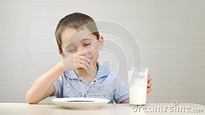The Child Drinks Milk and Eats a Sandwich. the Boy Eats a Sandwich with ...