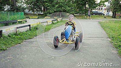 Child Rides On Cycle Mobile. Child Is Driving A Car. Slow Motion Stock ...