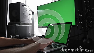 Chroma Key Green Screen. Man is Working on Laptop Computer with Green ...