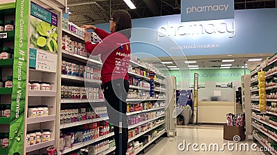 Clerk Stocking Medicine on Shelf at Pharmacy Section Stock Footage ...