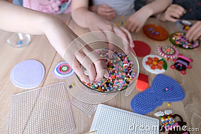 Close-up Of Children`s Hands Creating Perler Bead Patterns, Make Crafts ...