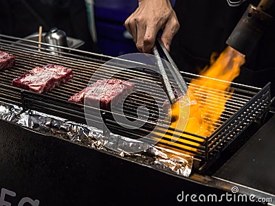 Close Up Hand Of Chef Using Flame Torch Burn On Japanese Wagyu Beef ...