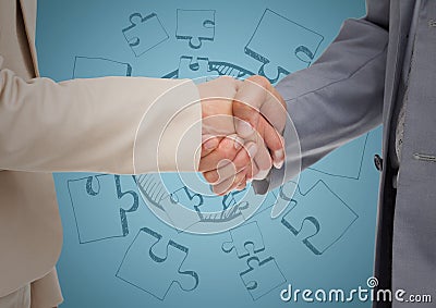 Close Up Of Handshake Against Blue Jigsaw Doodle And Blue Background ...