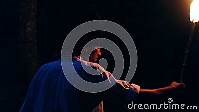 Closeup Of A Peasant Searching Through Forest Using A Wooden Torch ...