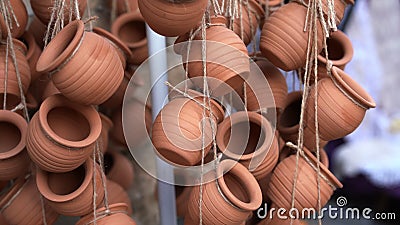 Closeup of Clay Ceramic Pots Hanging on Ropes and Fluttering on Wind ...
