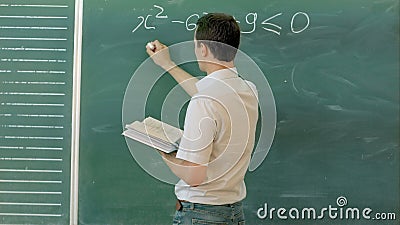 College Student Writing on the Chalkboard during a Math Class Stock ...