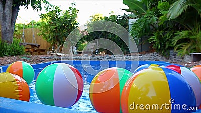 Colorful Beach Balls Floating in Pool in Slow Motion Stock Footage ...