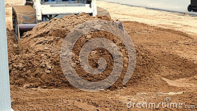Compact Front Loader Pushes a Pile of Brown Dirt . Stock Video - Video ...