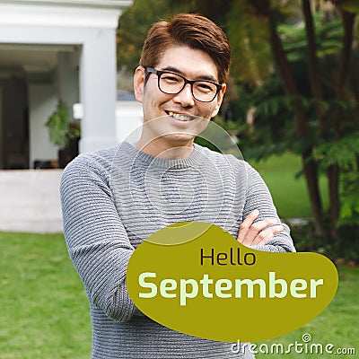 Composite Of Hello September Text Over Smiling Asian Man In Garden ...
