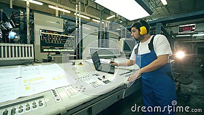 Computer Console and a Male Factory Worker Operating it Stock Footage ...