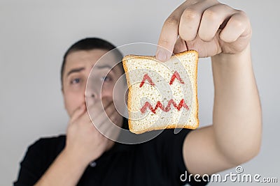 Conceptually About Gluten Intolerance. The Man Holds In His Hand A ...