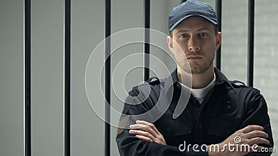 Confident Prison Security Guard Looking To Camera Standing Near Cell ...