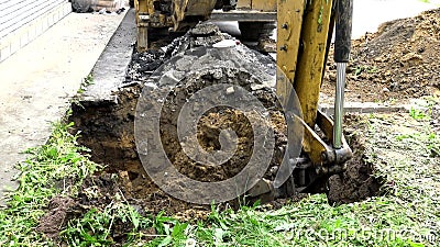 The Bucket of the Excavator Digs a Hole in the Ground. Stock Footage ...